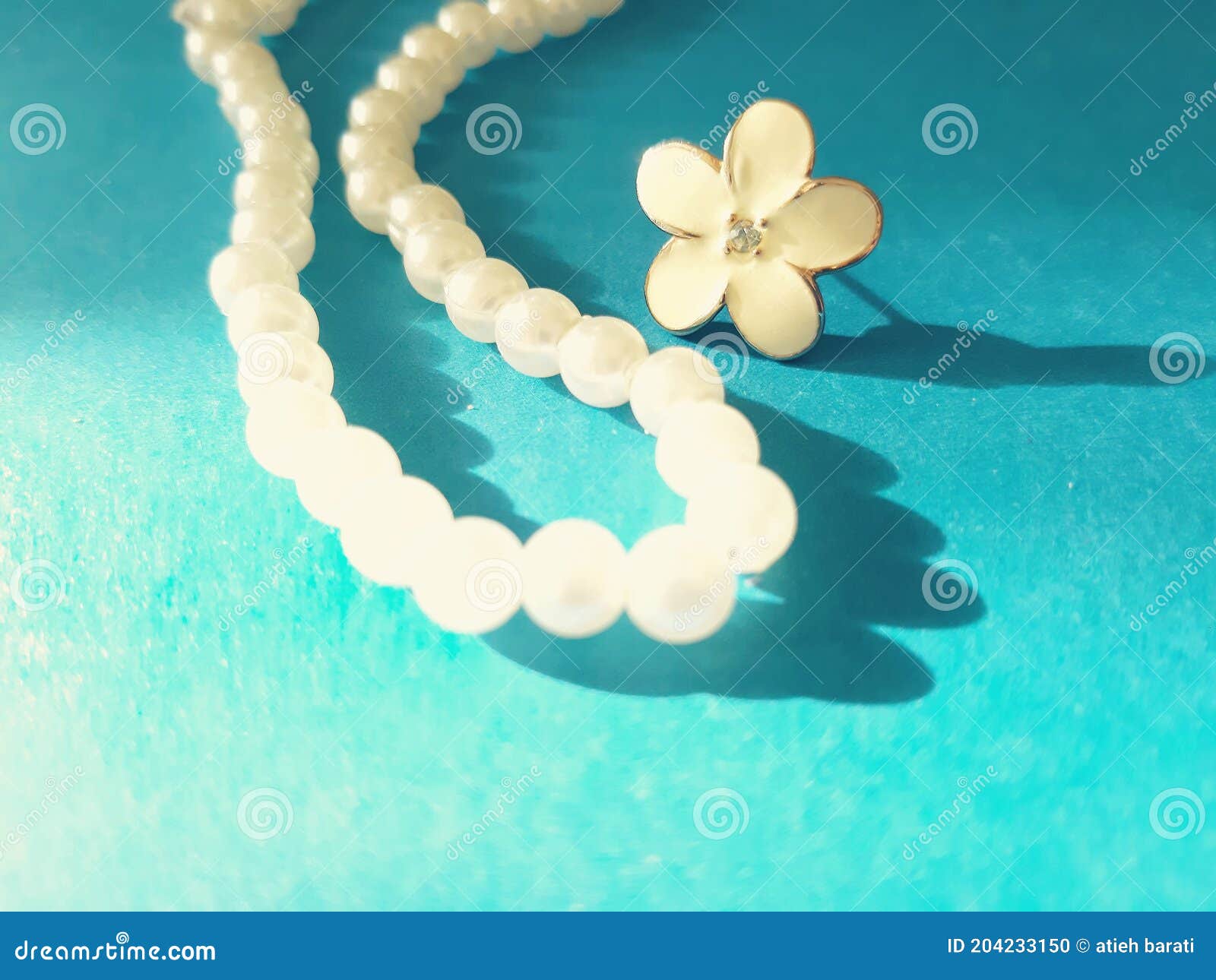 Shiny String of Pearls and Flower Stock Photo - Image of goldenflower ...
