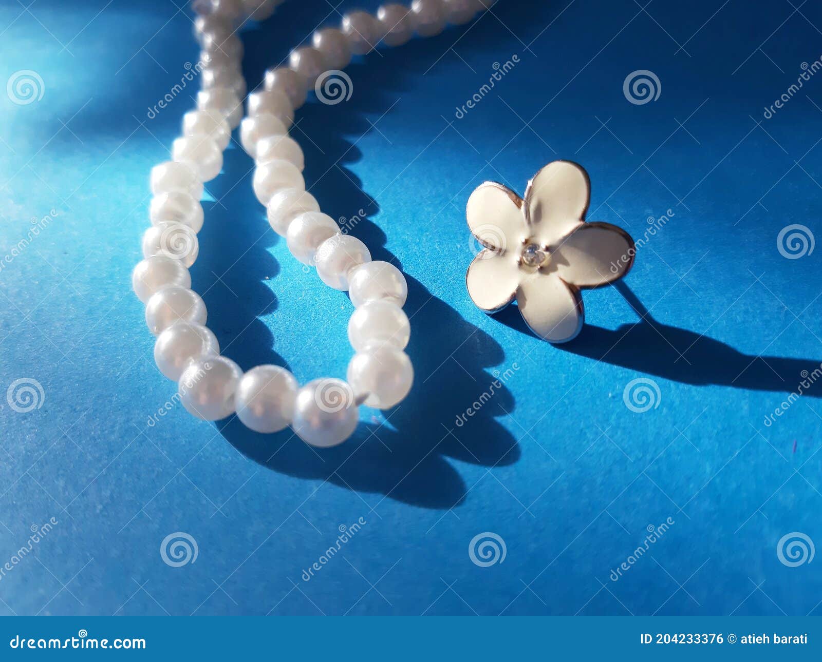 Shiny String of Pearls and Flower Stock Photo - Image of lighting, gift ...