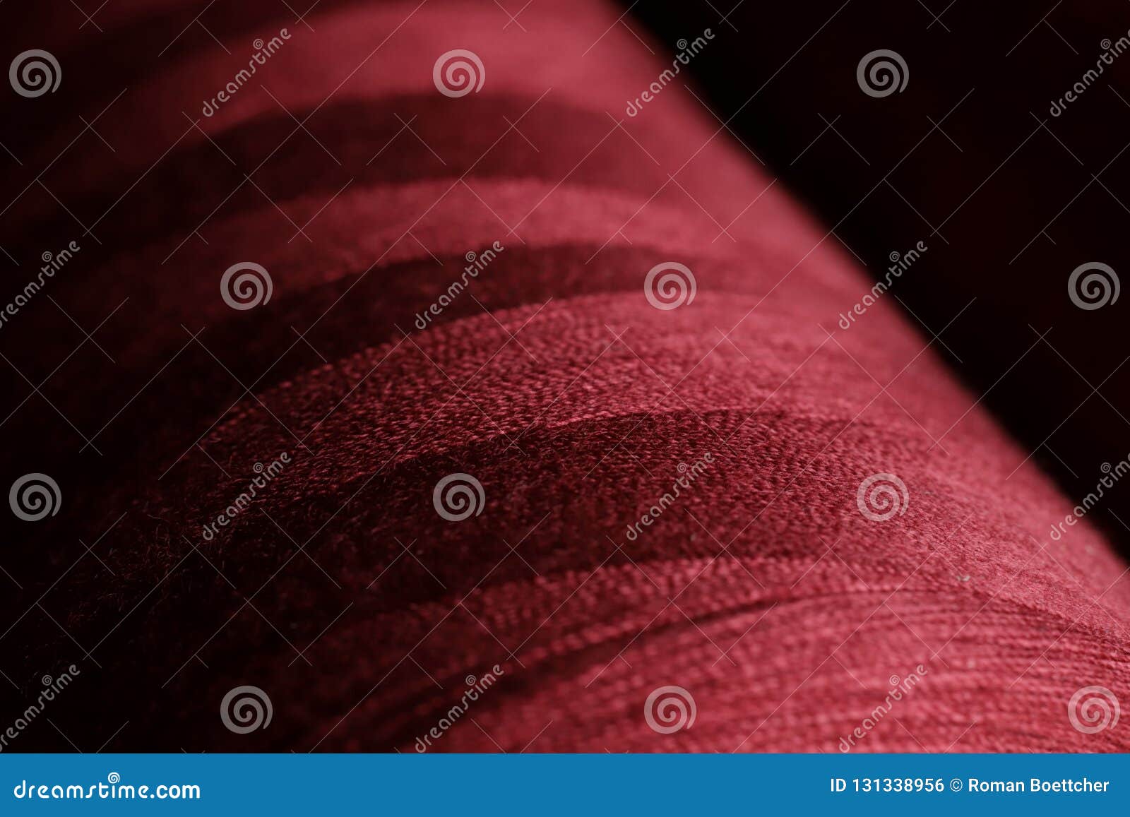 Shiny Surface of a Bobbin with Neat Wound Deep Red Thread in Dark ...