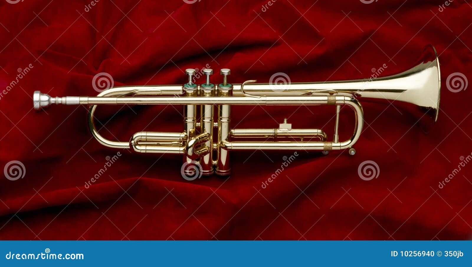 Shiny trumpet on red suede stock photo. Image of three - 10256940