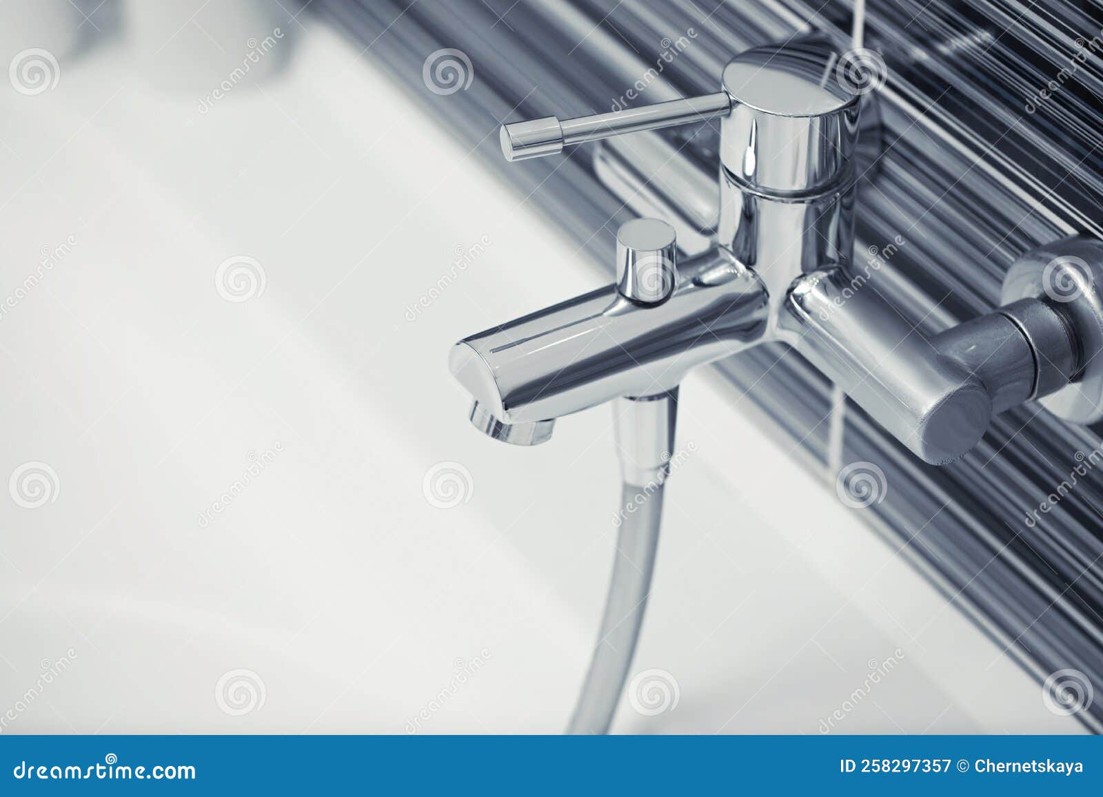 Shiny Water Tap Installed on Black and White Wall Above Bathtub Stock ...