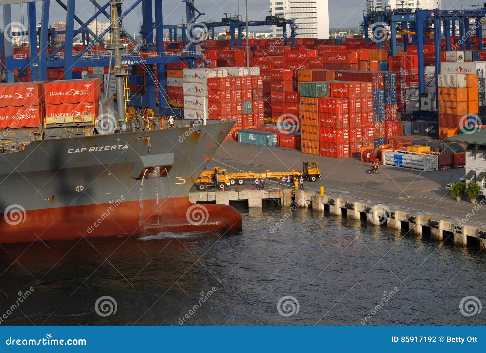 A Ship Being Unloaded, Trucks, Containers, and Cranes Editorial ...