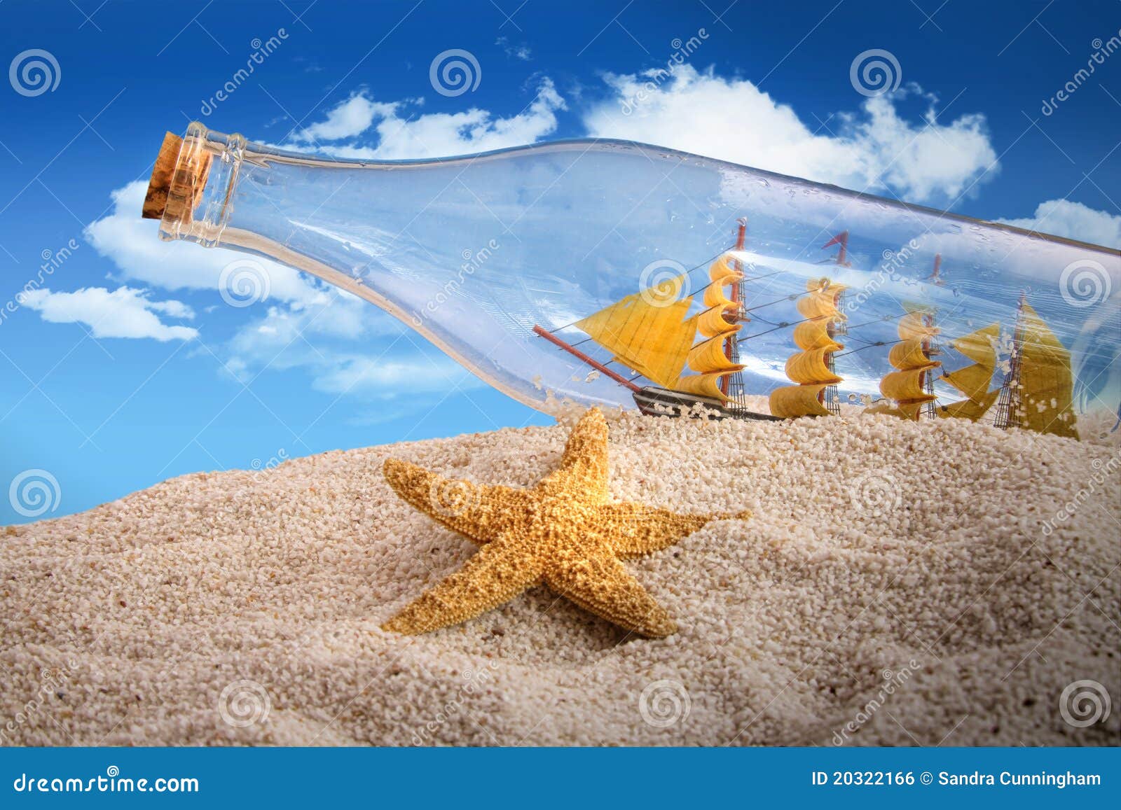 Ship in a Bottle in a Pile of Sand Stock Photo - Image of cloud, ship ...