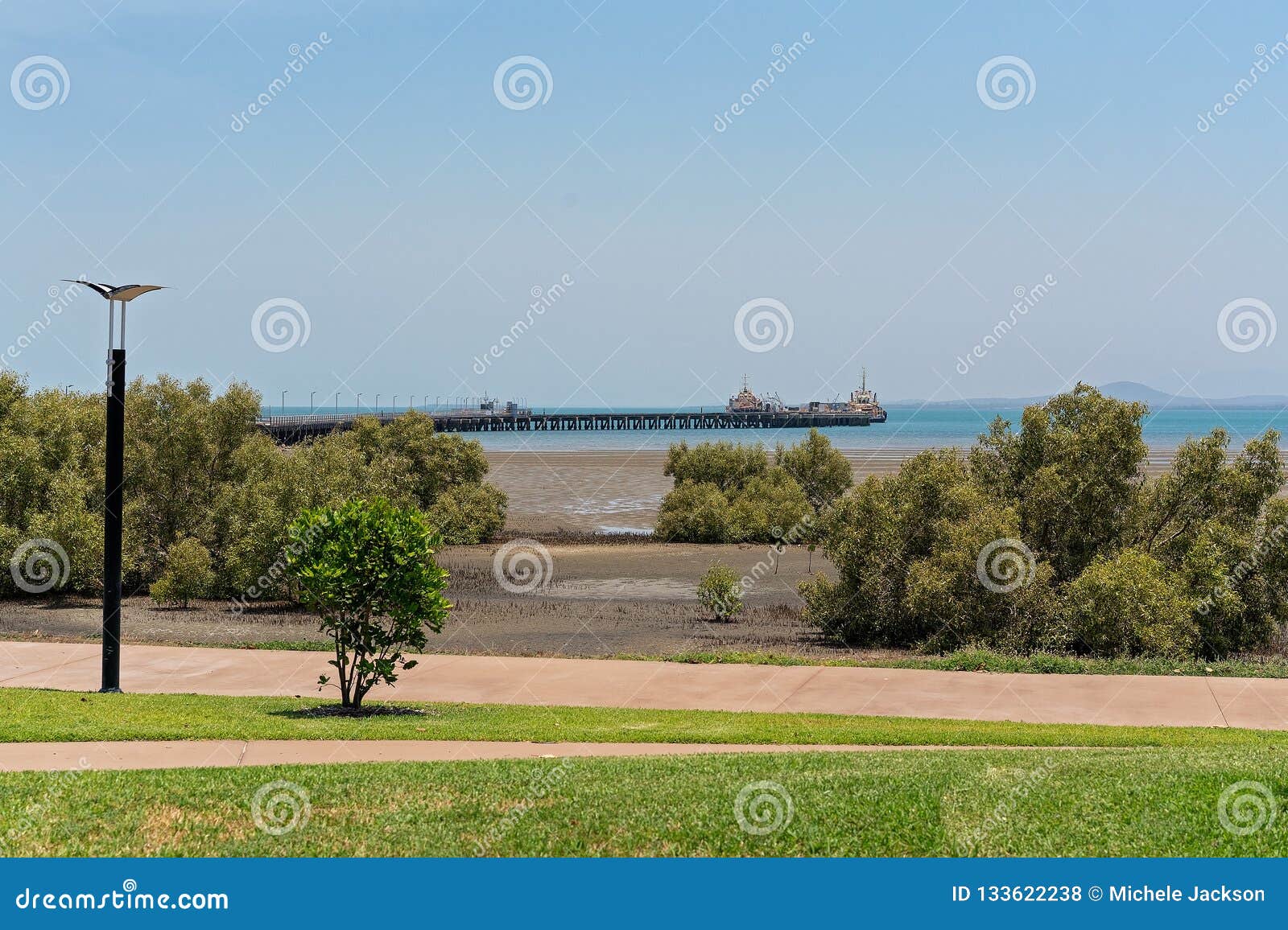 Ship Loading Cargo at a Pier Stock Photo - Image of machine, bushes ...
