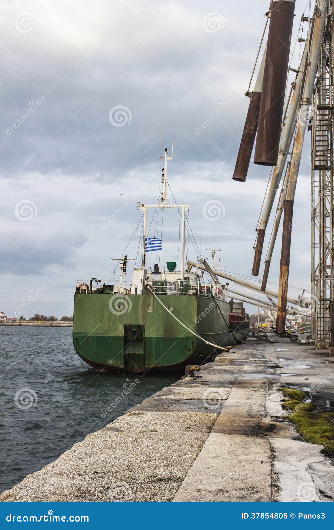 Loading Grain Into Holds Of Sea Cargo Vessel In Seaport From Silos Of ...