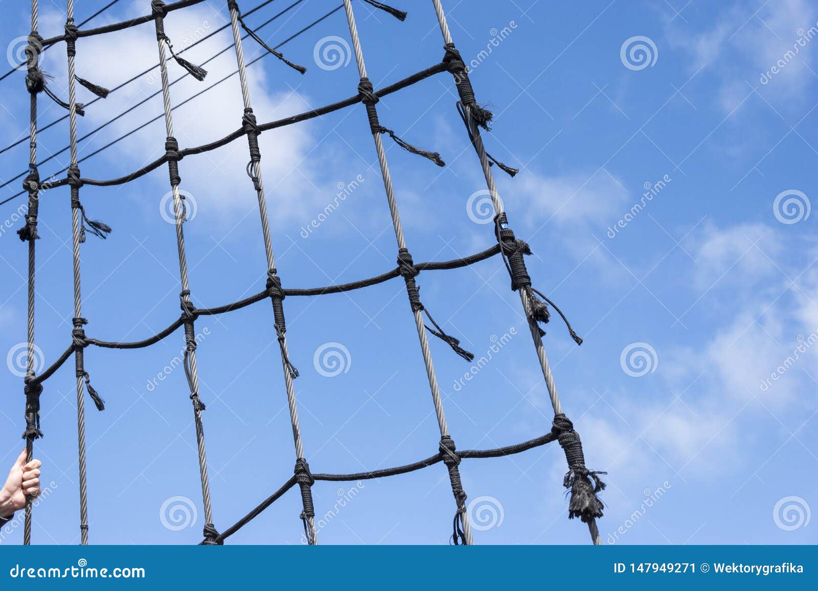 Ship Rigging on a Blue Sky Background with the Hand Holding the Line ...