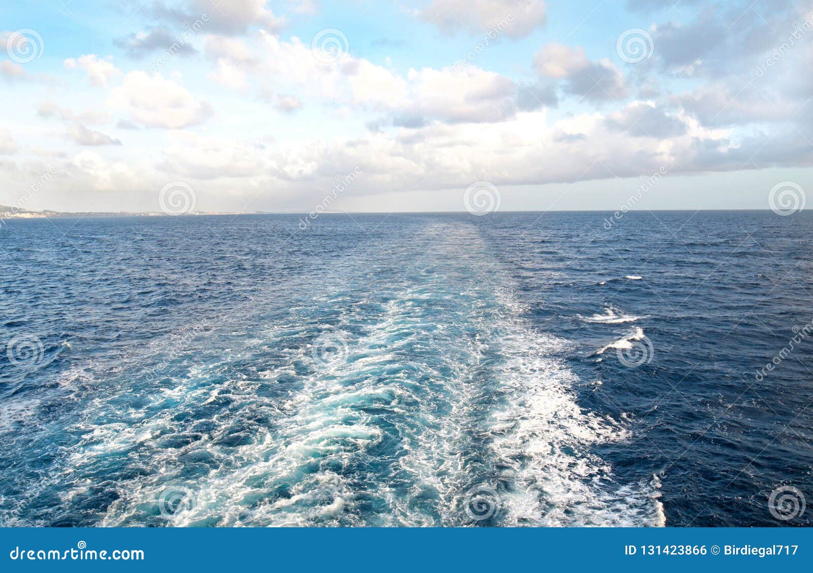 Ship`s Wake Behind a Cruise Ship. Cloudy Blue Sky Background Stock ...