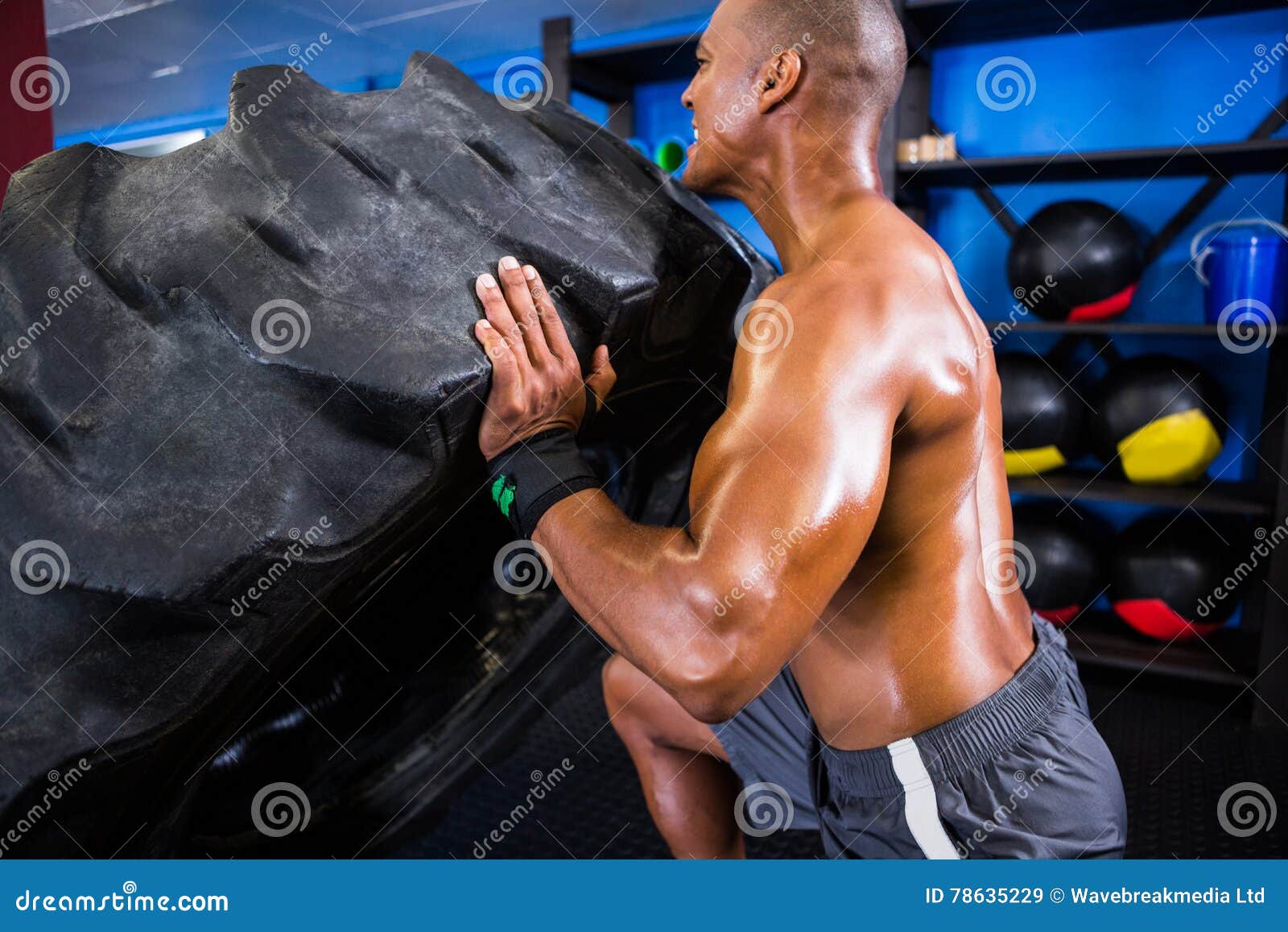 Shirtless Athlete Pushing Tire Stock Image - Image of quarter, effort ...
