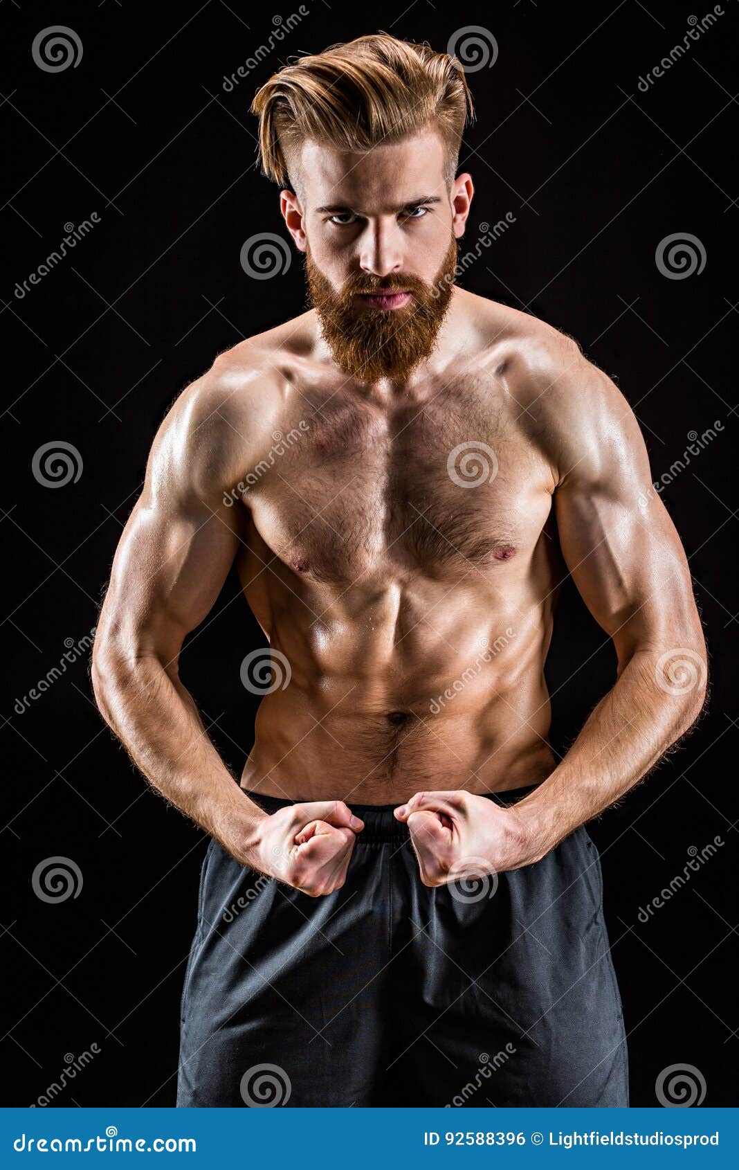 Shirtless Bearded Bodybuilder Posing Isolated on Black Stock Photo ...