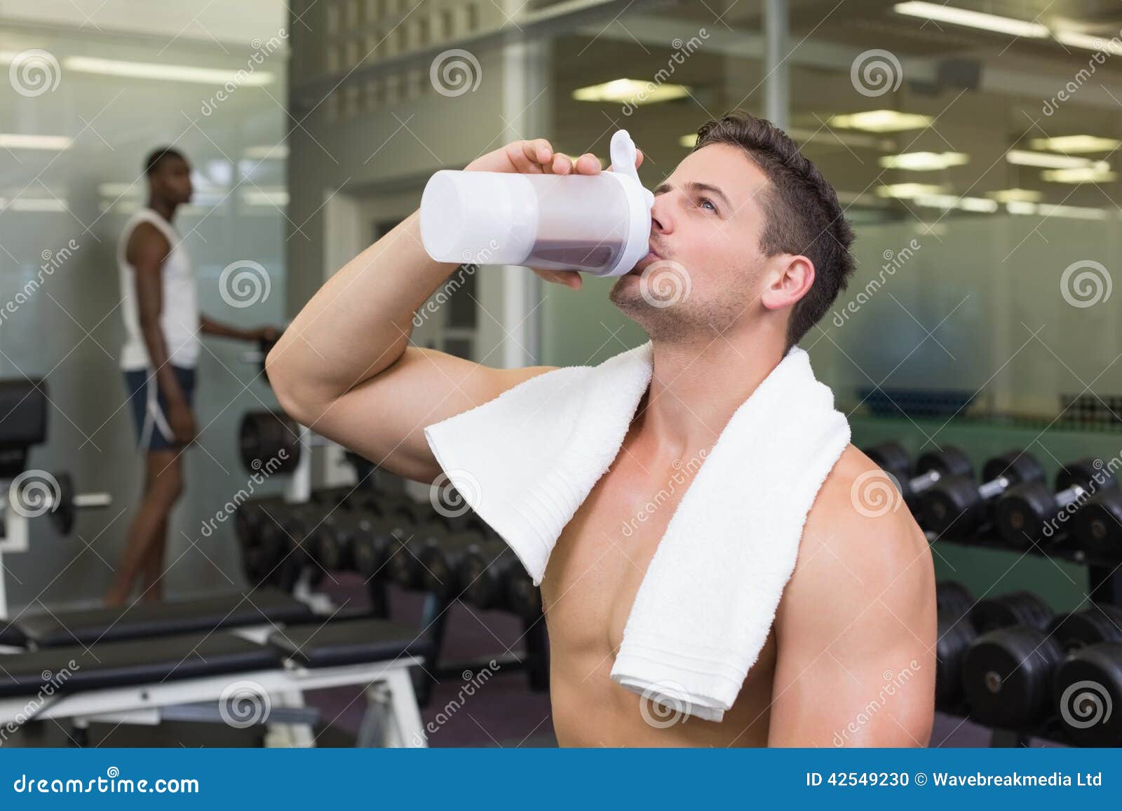Shirtless Bodybuilder Drinking Protein Drink Sitting on Bench Stock ...
