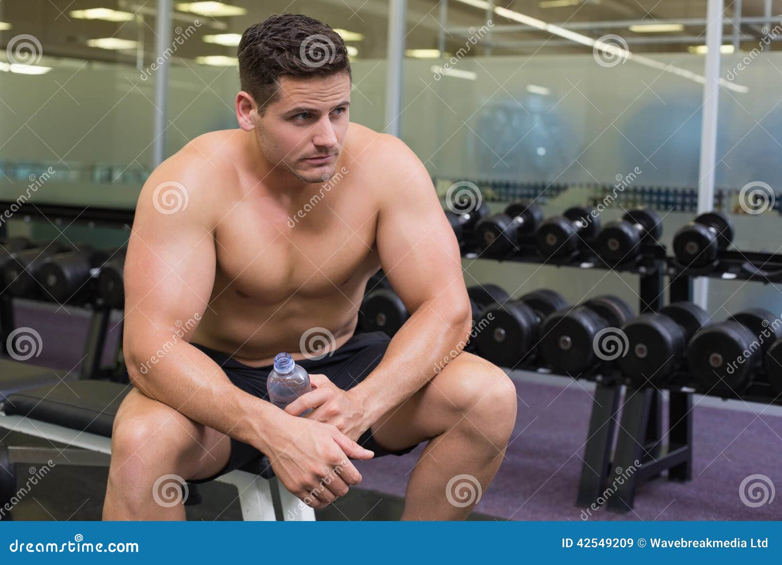 Shirtless Bodybuilder Sitting on Bench with Water Bottle Stock Image ...