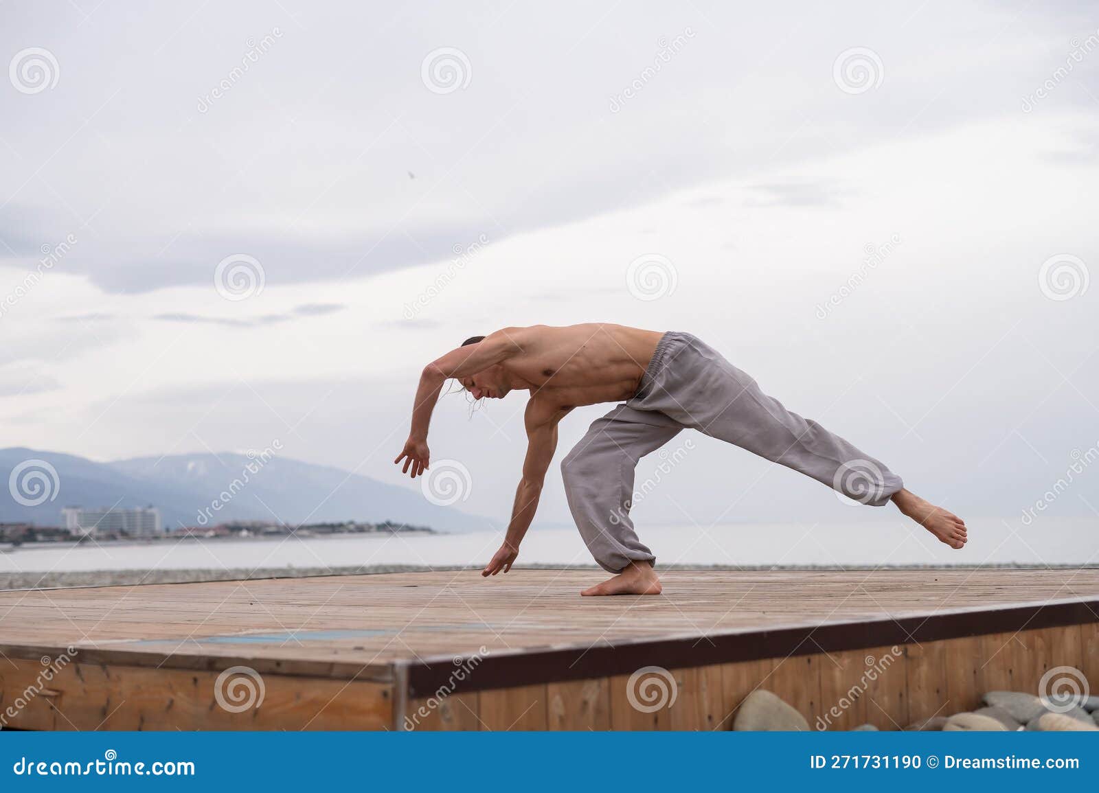 Shirtless Caucasian Man Doing Acrobatic Wheel on the Beach. Stock Photo ...