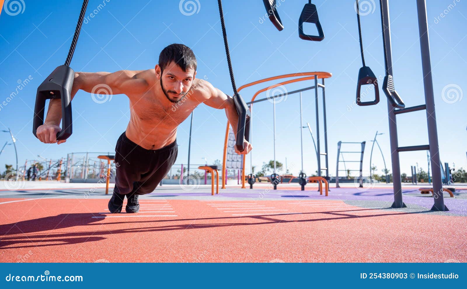 Shirtless Man Doing Loop Exercises Outdoors. Stock Image - Image of ...
