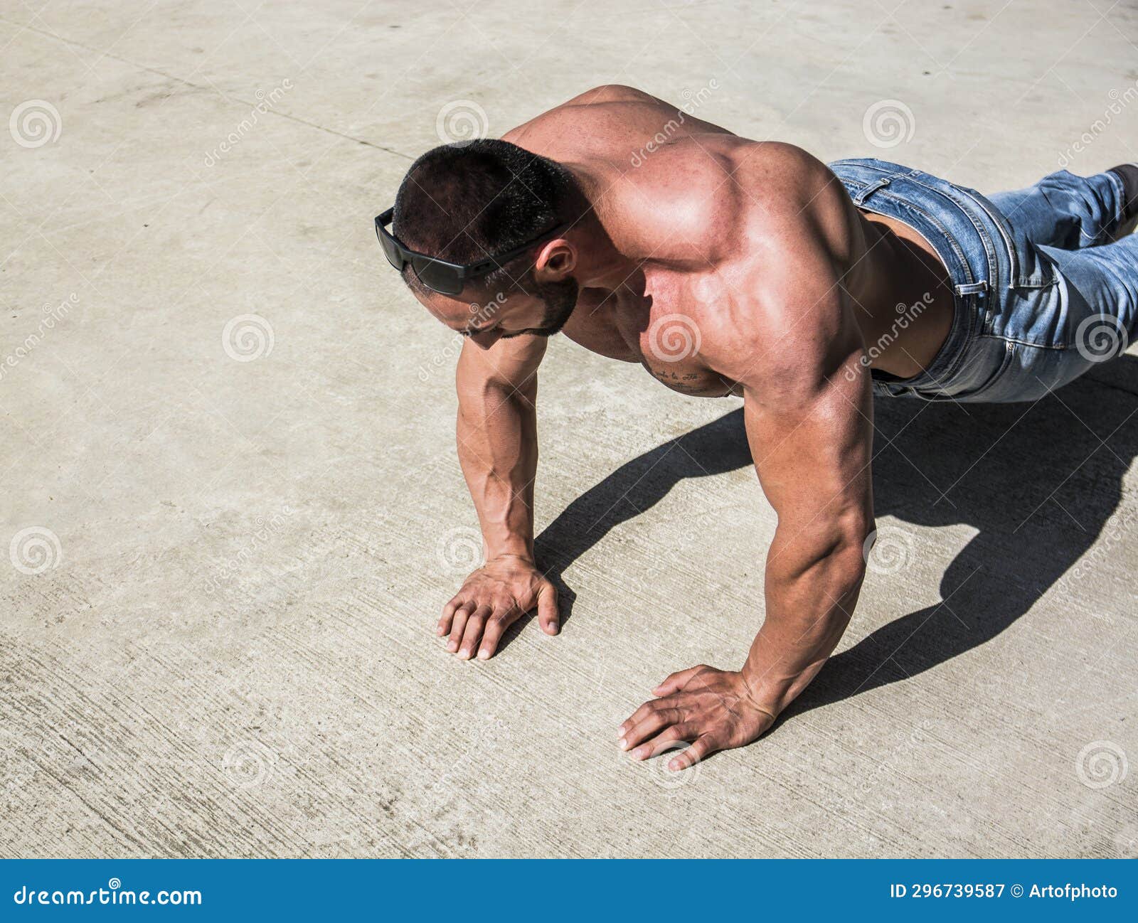 Photo of a Muscular Man Performing Push-ups on a Concrete Surface Stock ...