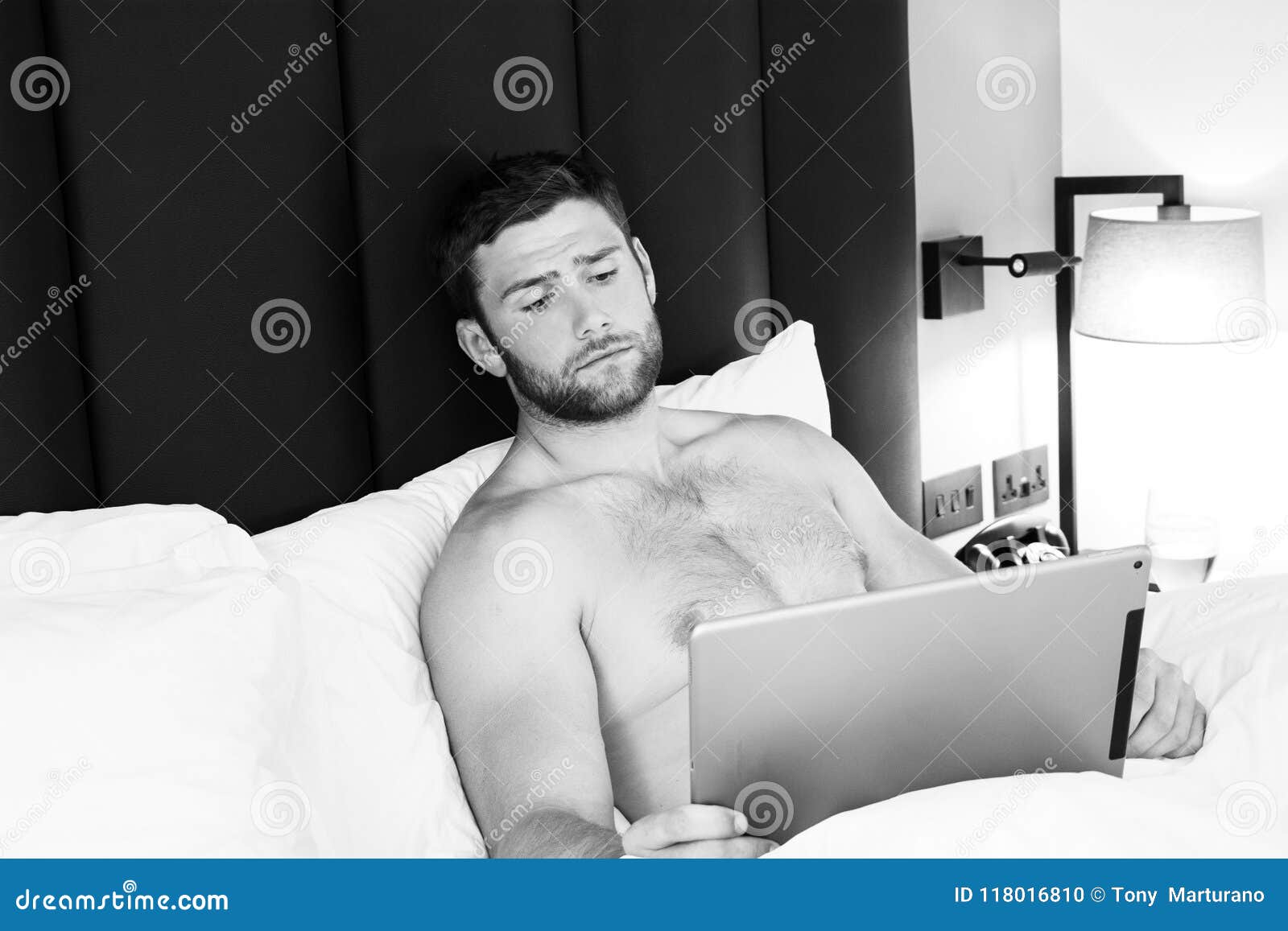 Shirtless Hunky Man With Beard Lies Naked In Bed Royalty Free Stock