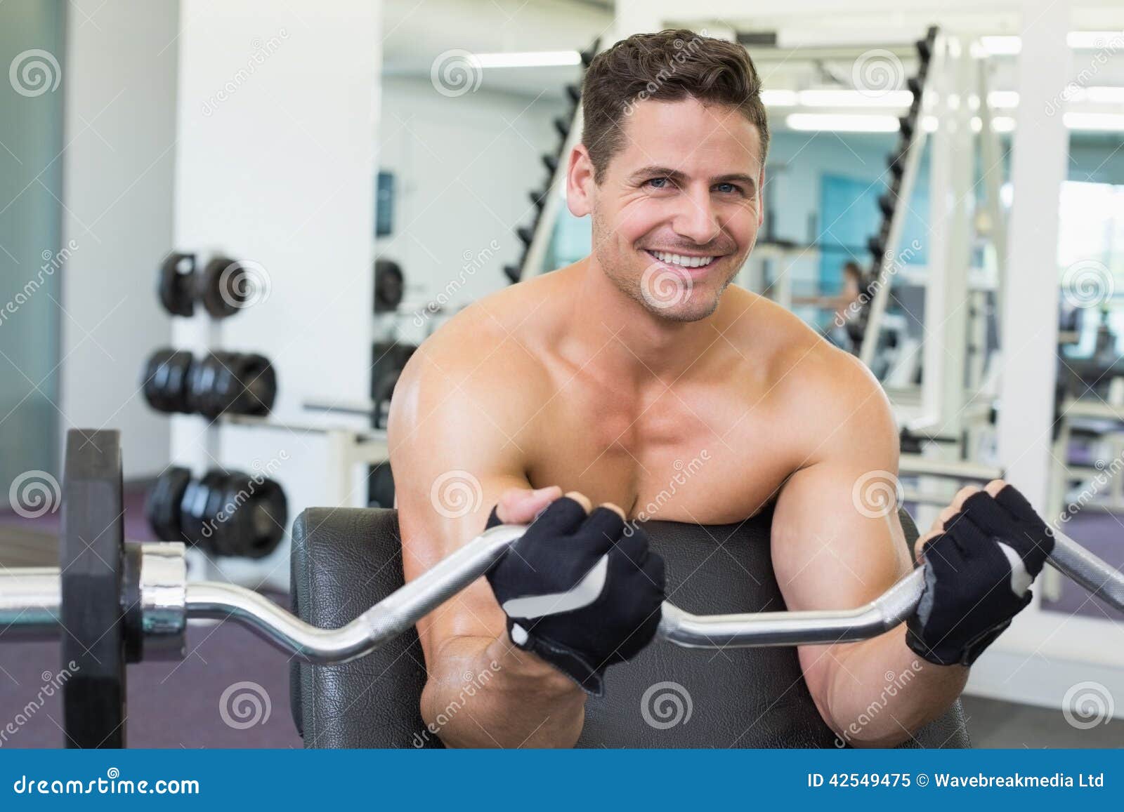 Shirtless Smiling Bodybuilder Lifting Heavy Barbell Weight Using Bench ...