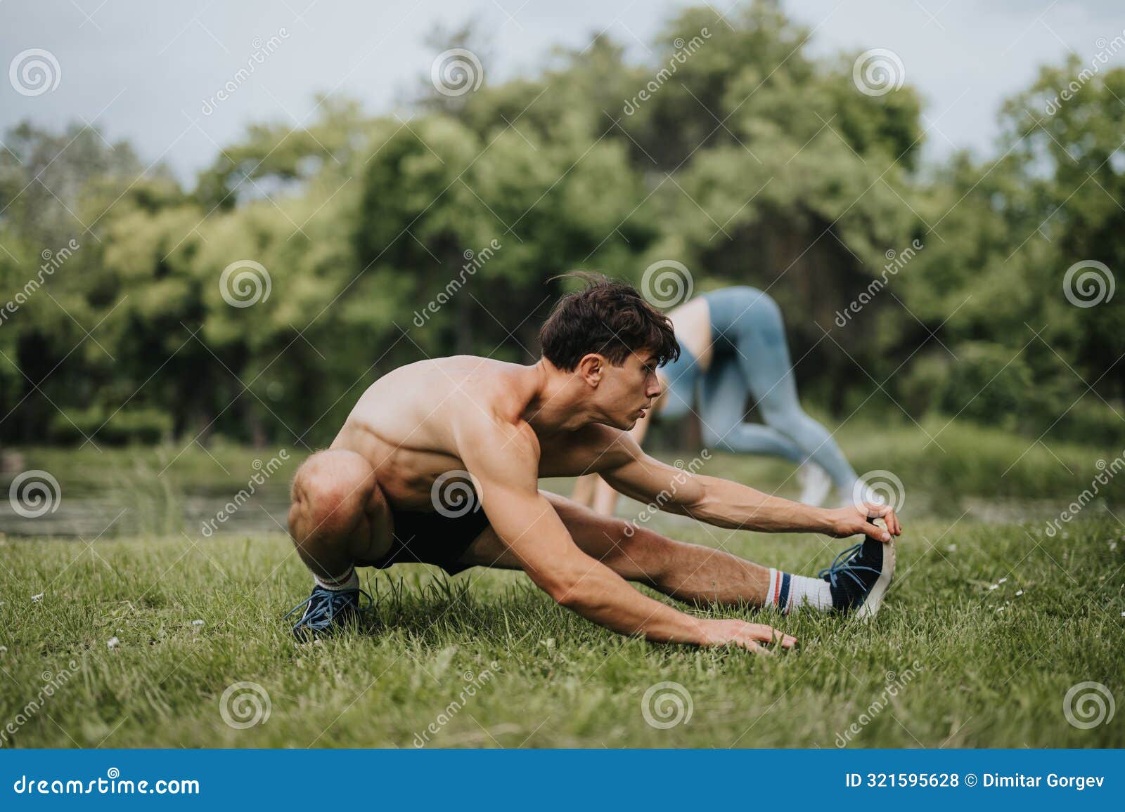 Young Man Stretching before Workout in Nature, Focusing on Flexibility ...