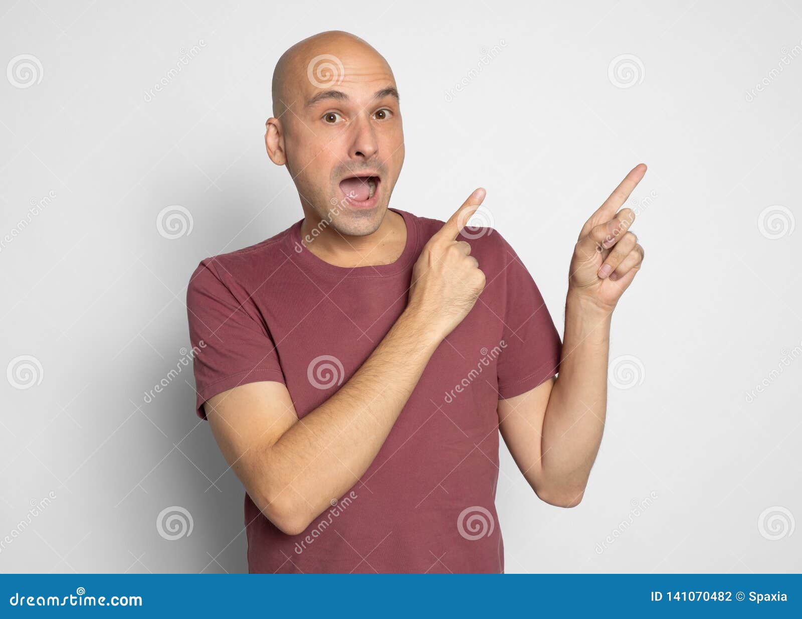 Shocked Bald Man Pointing Fingers Aside. Isolated Stock Photo - Image ...