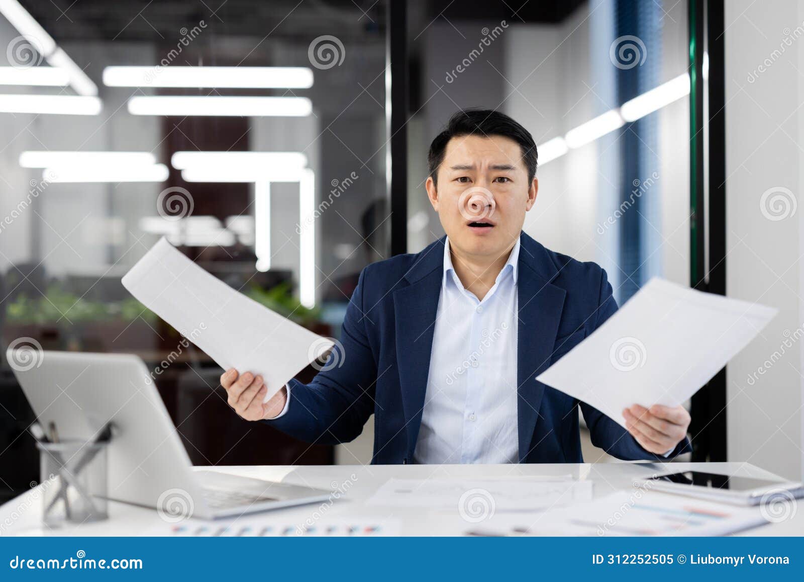 Shocked Chinese Office Worker Sitting at Personal Workplace with ...