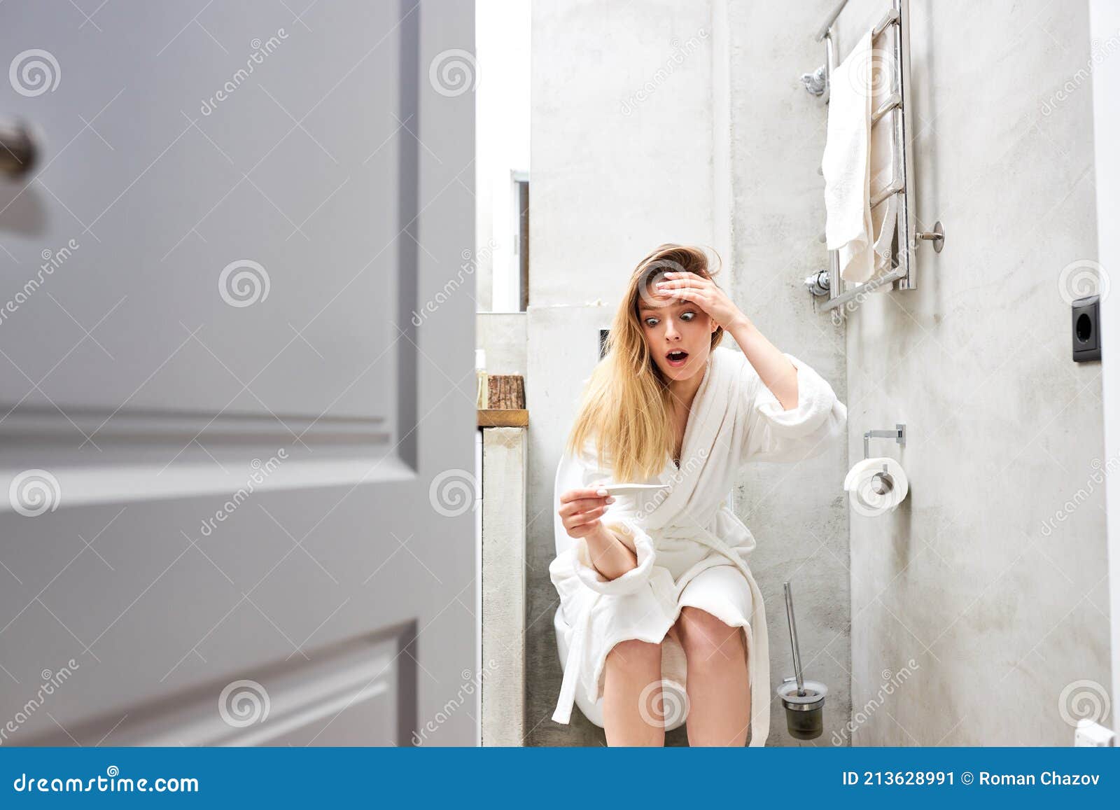 Shocked Female Looking At Control Line On Pregnancy Test While Sitting