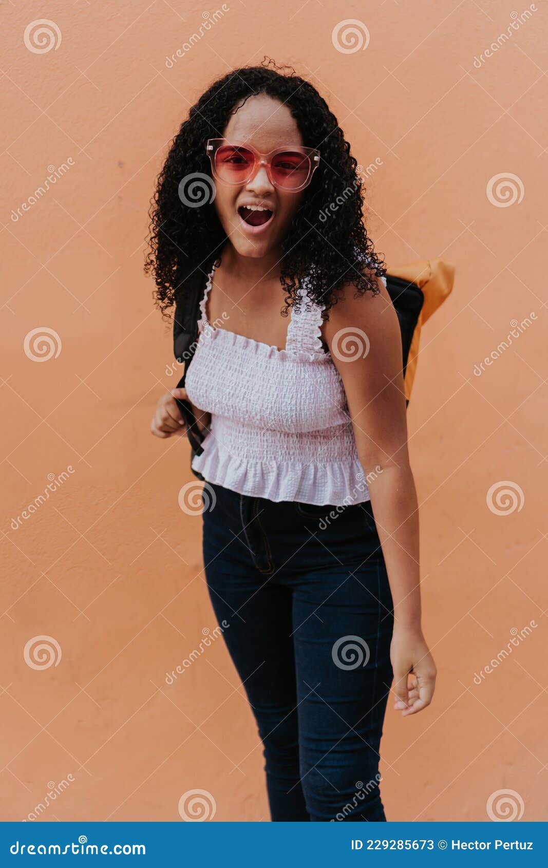 Shocked Girl Carrying Backpack while Standing in Front of Wall Stock ...