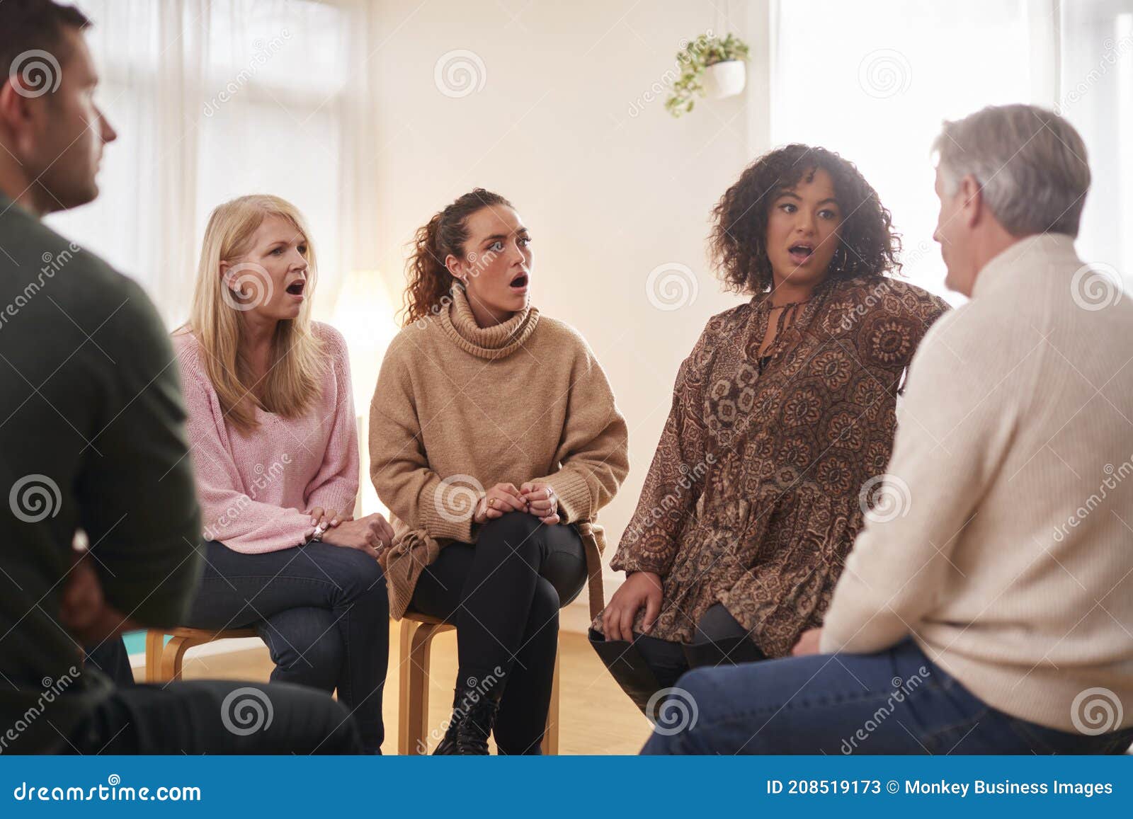 Shocked Group Consoling Man Speaking at Support Group Meeting for ...