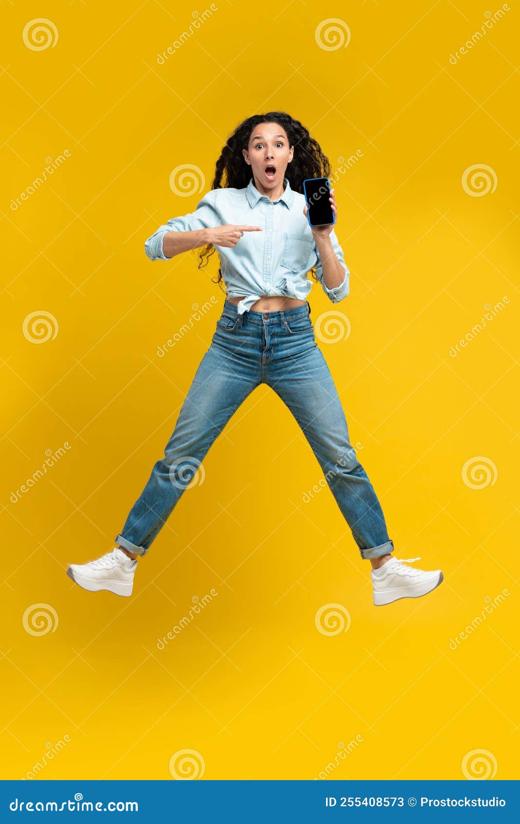 Shocked Lady Showing Smartphone Empty Screen Jumping Over Yellow ...