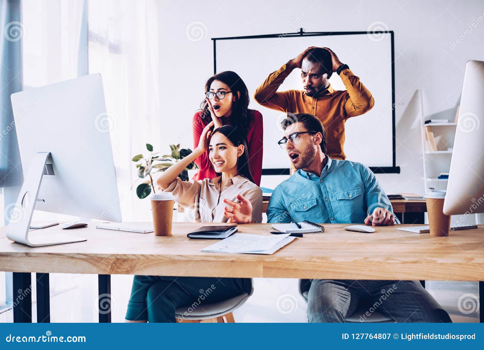 Shocked Multiracial Business Team Working on Project Together Stock ...