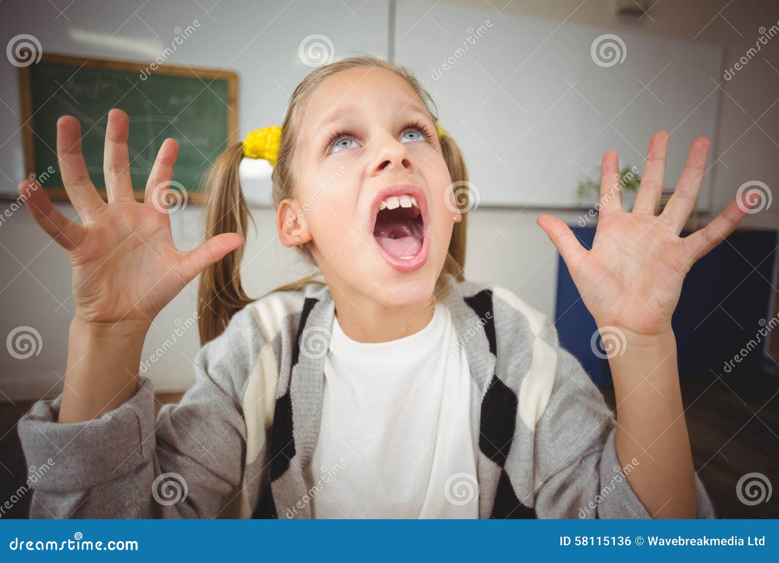 Shocked Pupil Sitting at Her Desk in a Classroom Stock Photo - Image of ...