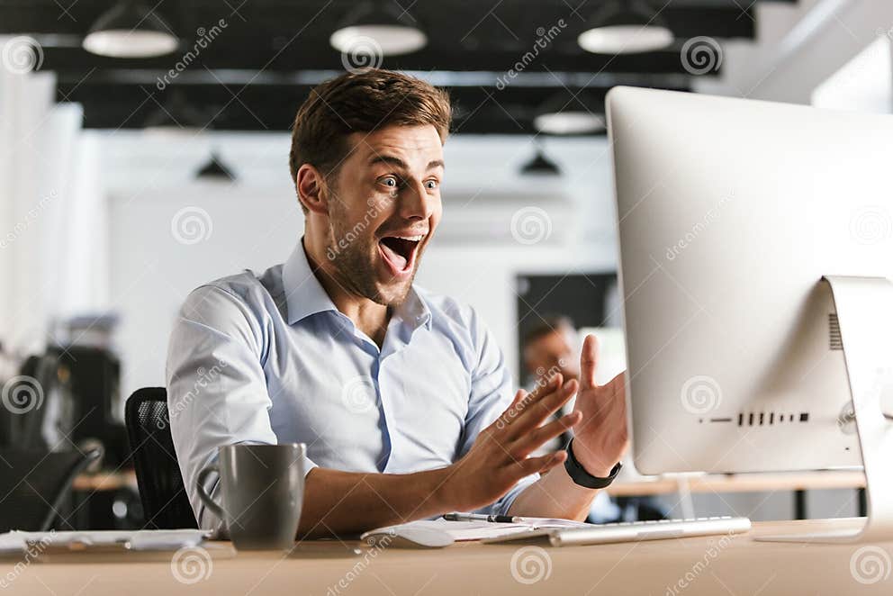 Shocked Screaming Business Man Using Computer while Sitting by Table ...