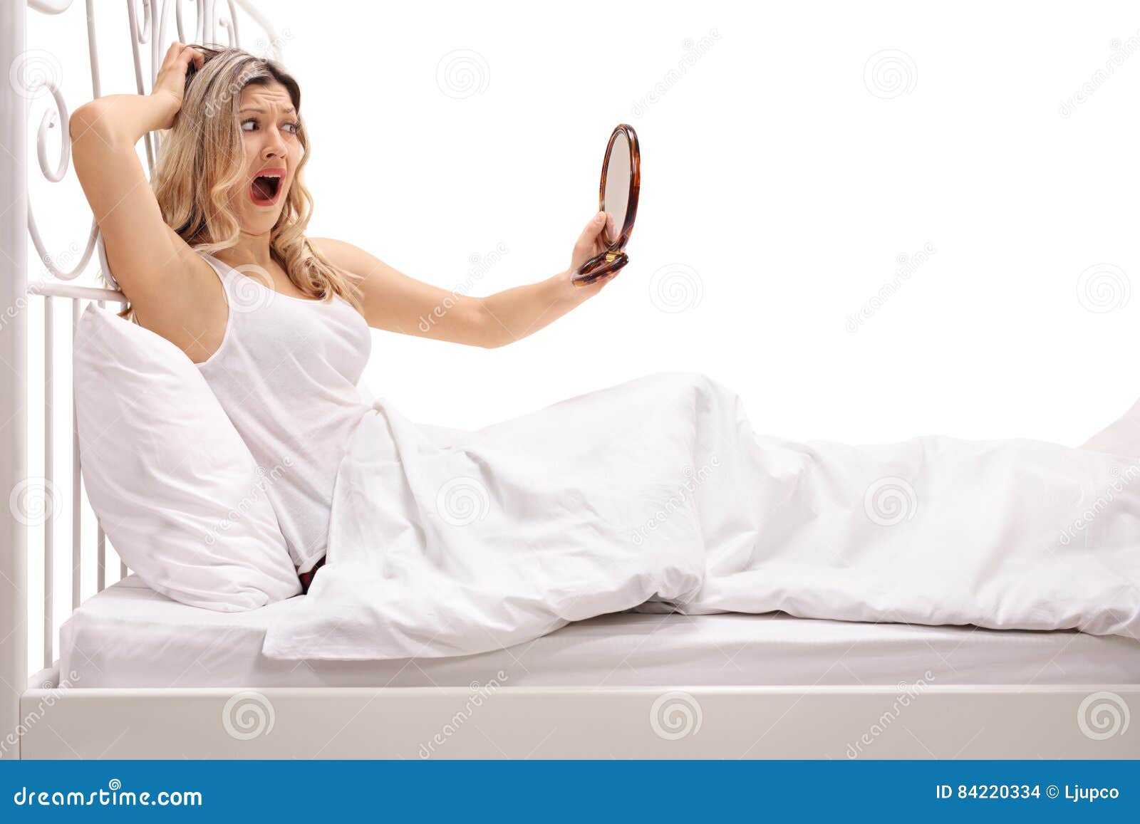 Shocked Woman Lying in Bed and Looking at a Mirror Stock Photo - Image ...
