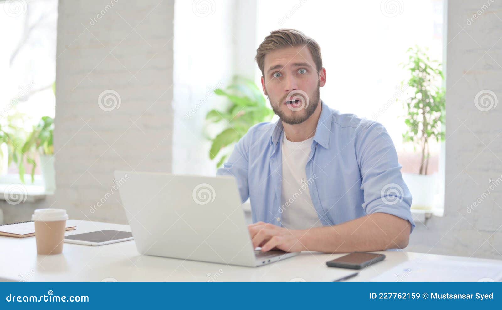 Shocked Young Man in Modern Office Stock Image - Image of office ...