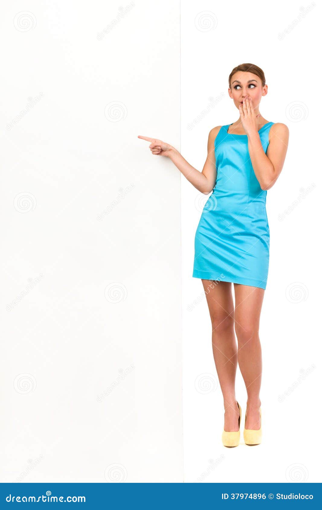 Shocked Young Woman Standing and Pointing at a Banner. Stock Photo ...