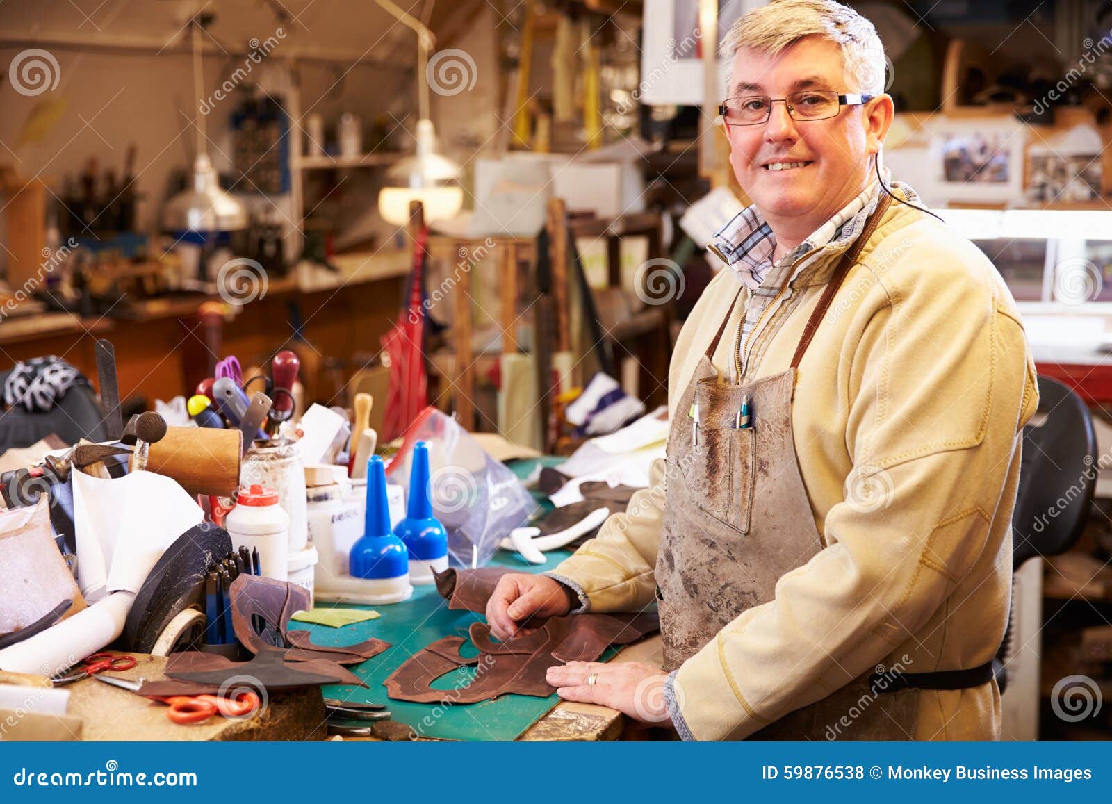 Shoemaker Cutting and Gluing Leather in a Workshop Stock Photo - Image ...