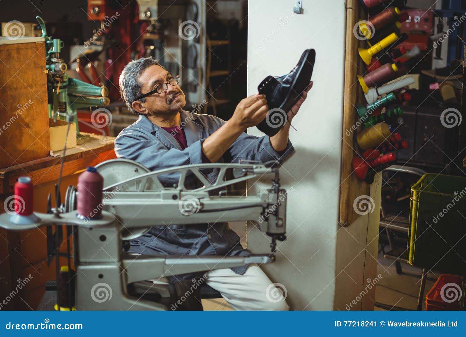 Shoemaker examining a shoe stock image. Image of clothing - 77218241