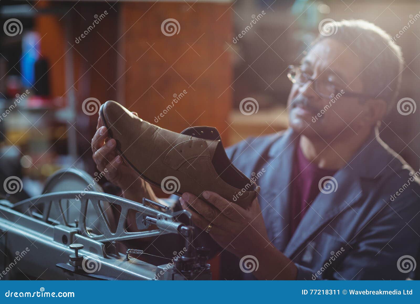 Shoemaker examining a shoe stock image. Image of occupation - 77218311