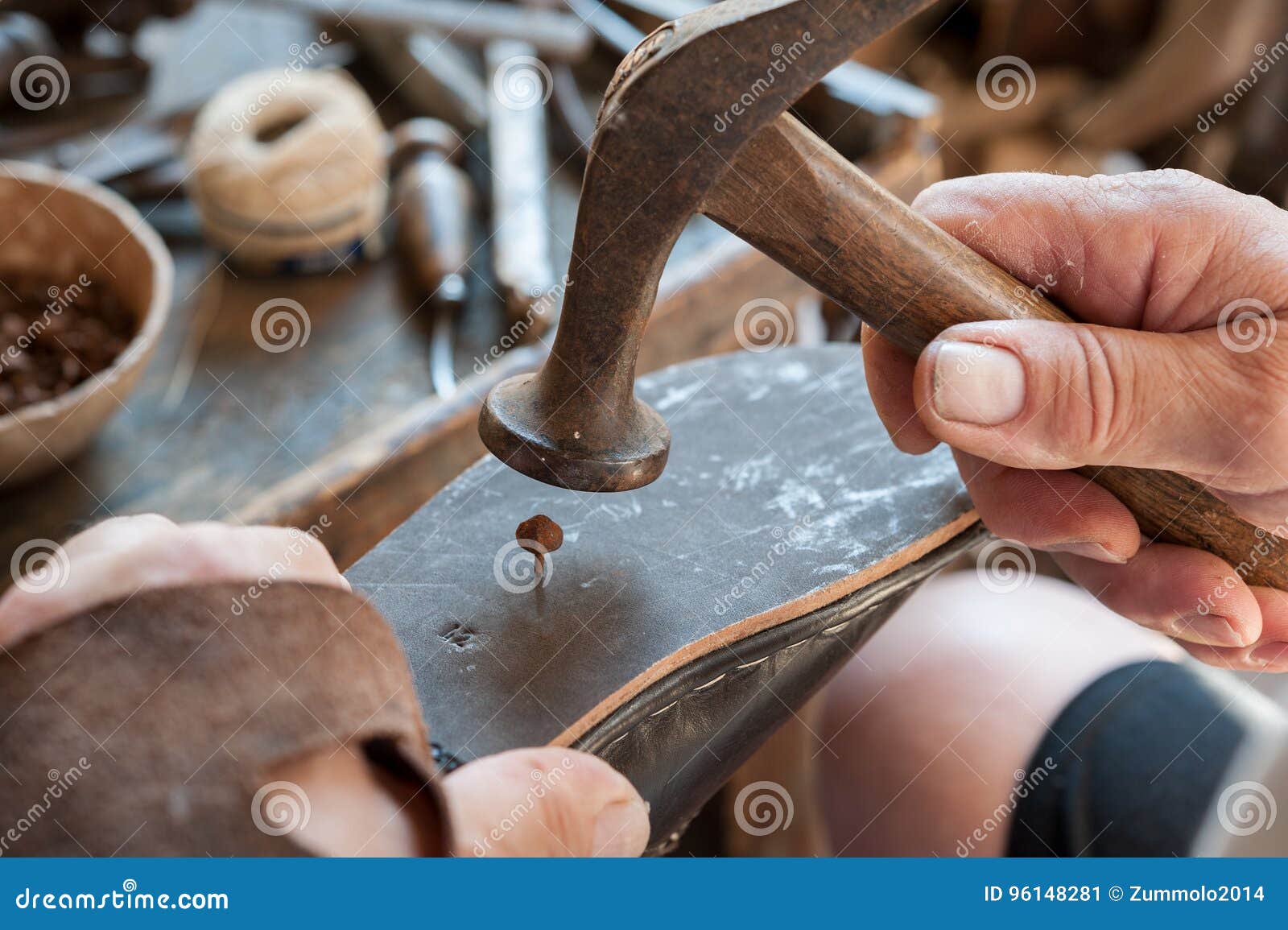 The Shoemaker Repairs a Shoe at His Work Bench Stock Image - Image of ...
