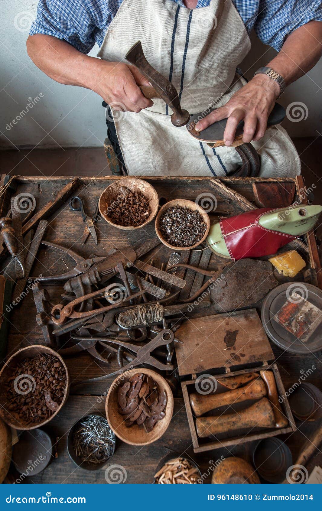 The Shoemaker Repairs a Shoe at His Work Bench Stock Photo - Image of ...