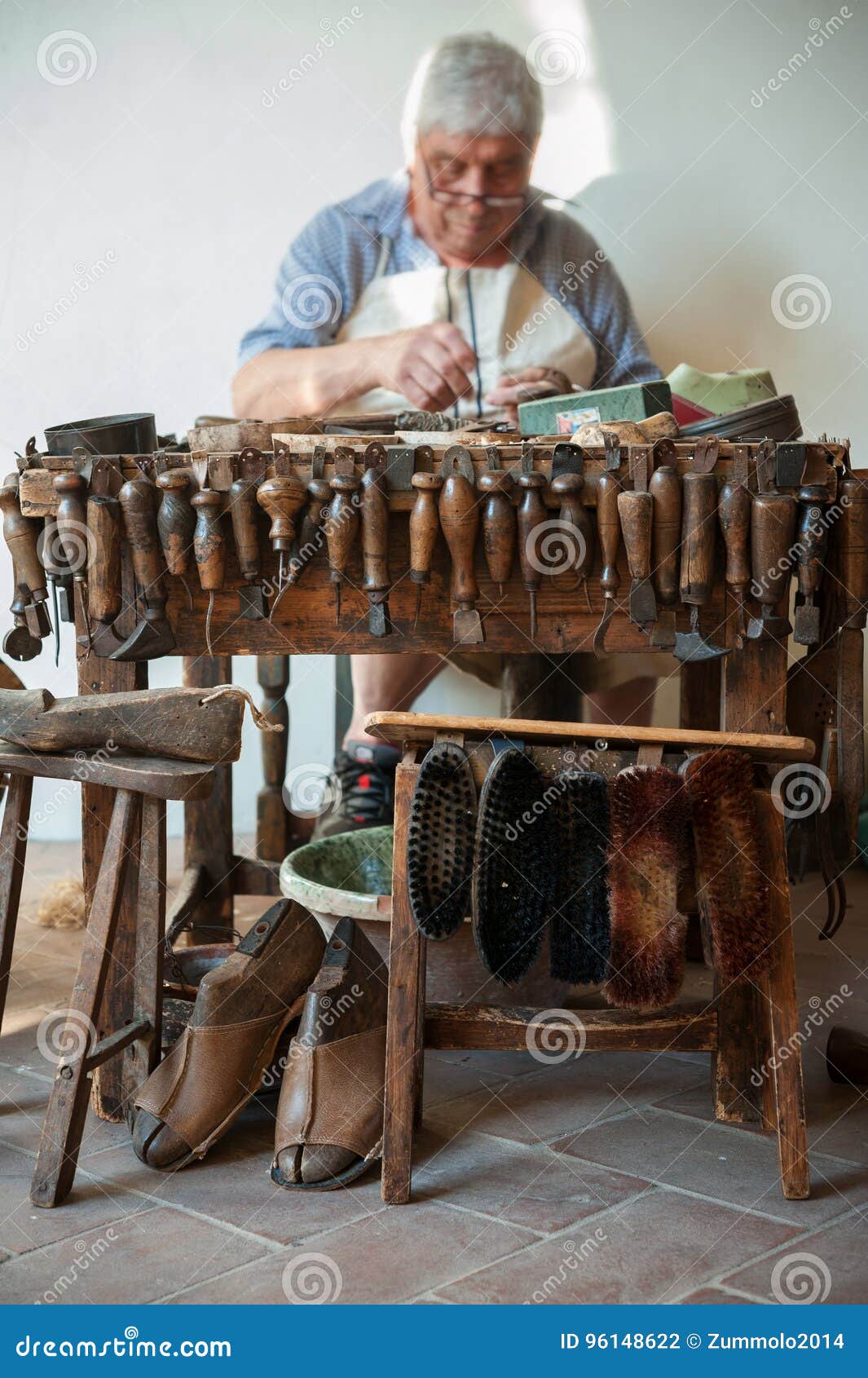The Shoemaker Repairs a Shoe at His Work Bench Stock Photo - Image of ...