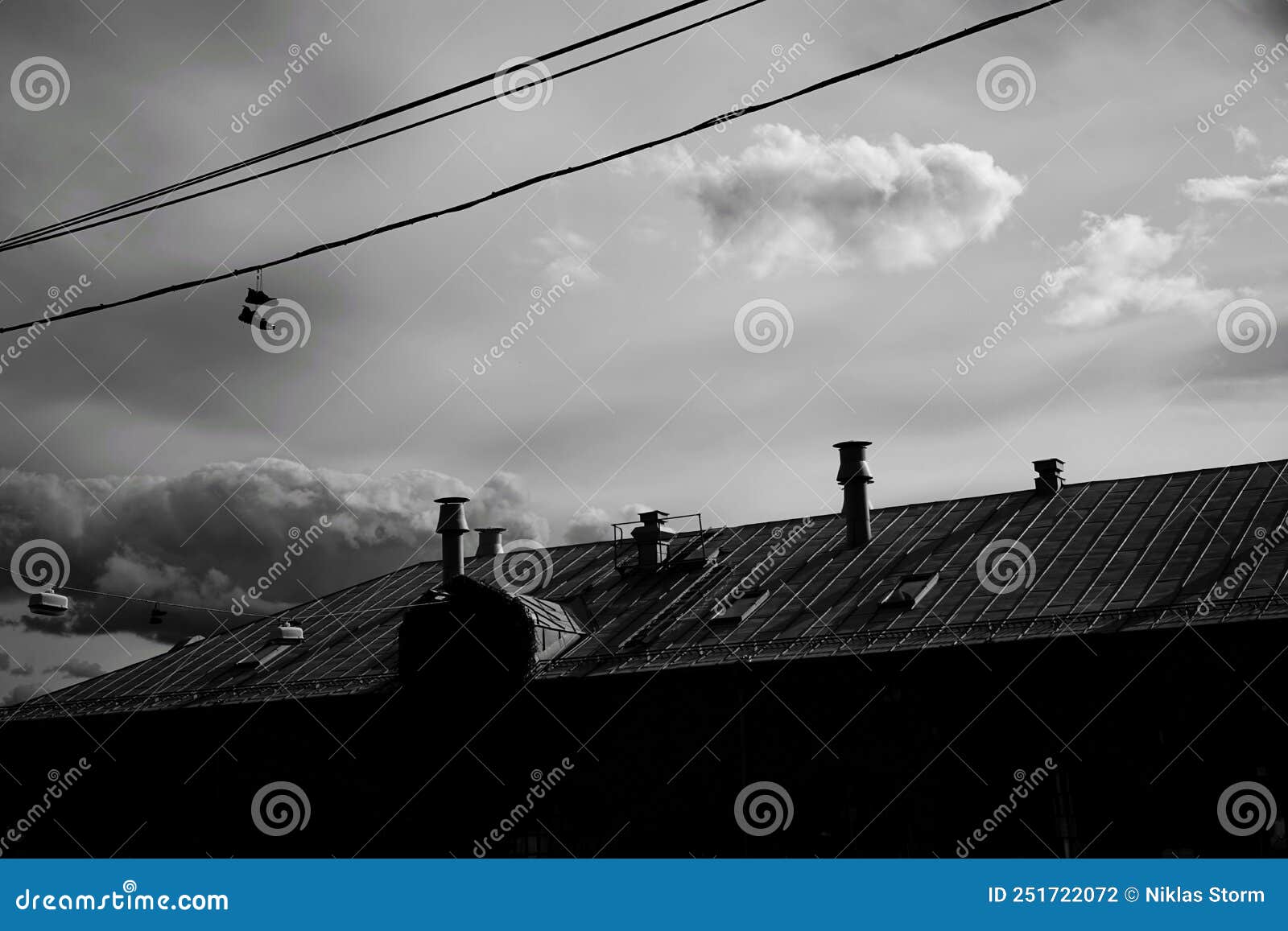 Shoes Hang on Cable Above Building Stock Photo - Image of building ...
