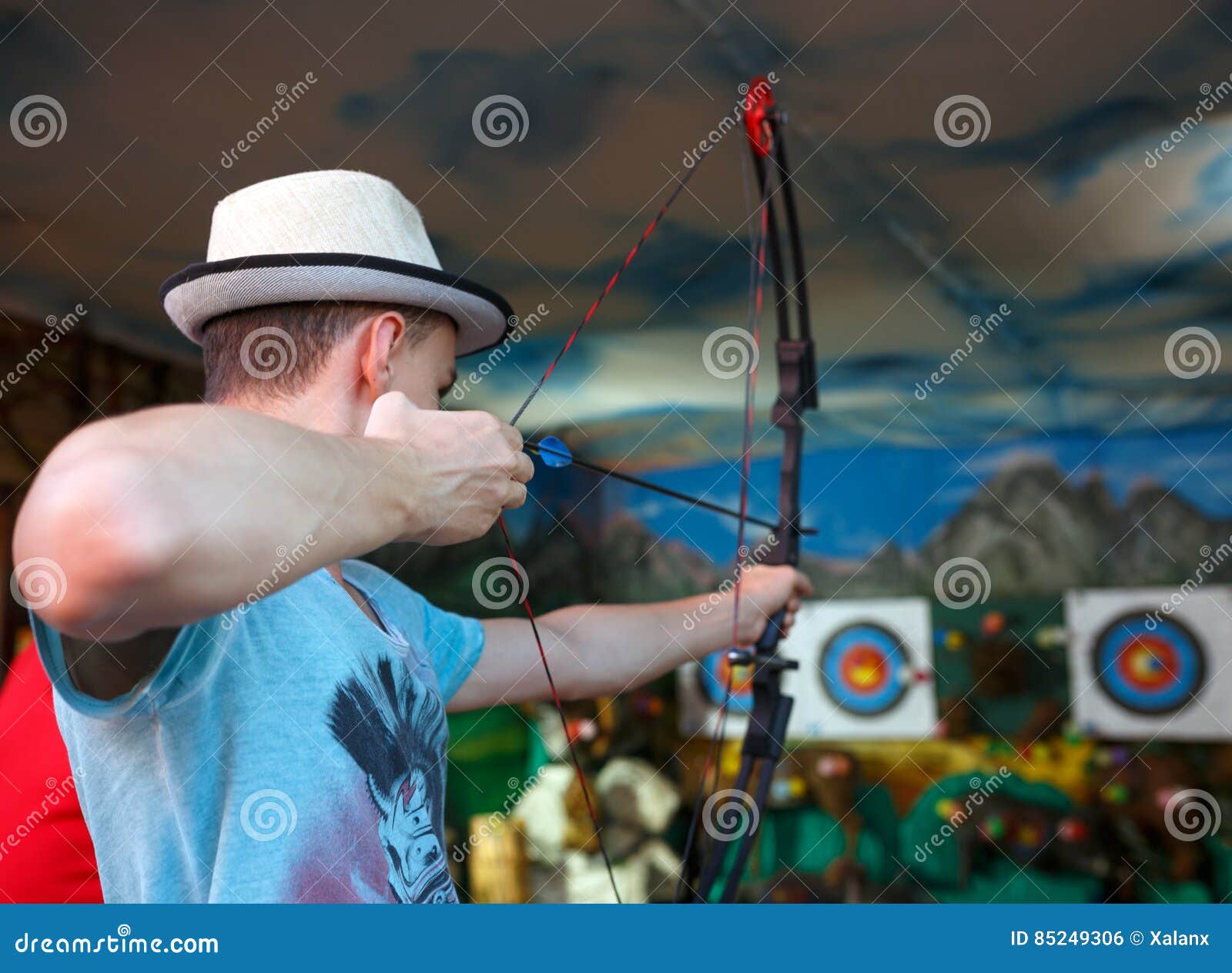 Shooting with a Bow at an Amusement Park Stock Photo - Image of indoor ...