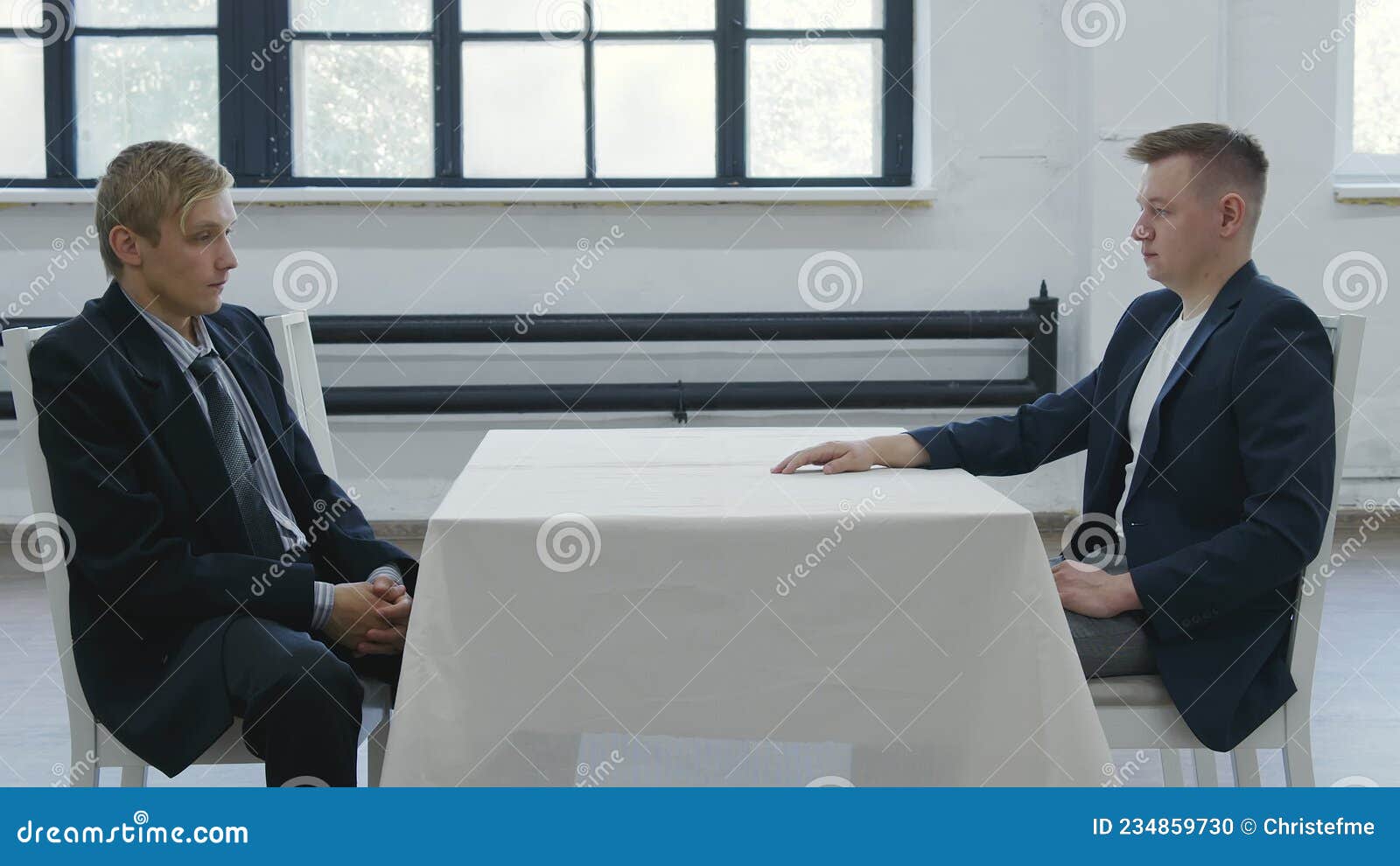 Shooting of Two Men Sitting Facing Each Other at the Table Stock ...