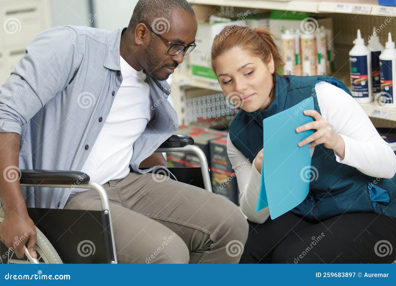 Shop Assistant Helping Handicaped Man in Hardware Store Stock Image ...