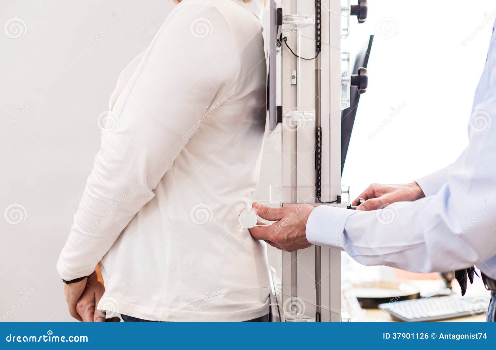 Shop Assistant Measuring the Back of a Customer Stock Photo - Image of ...