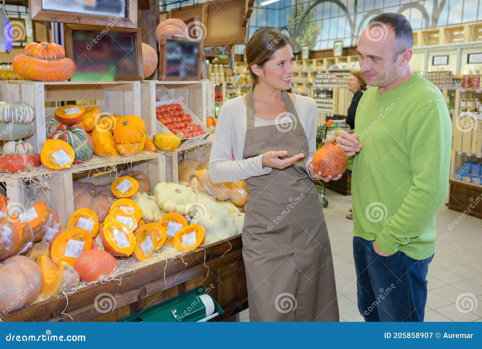Shop Assistant Showing Pumpkin To Customer Stock Image - Image of show ...