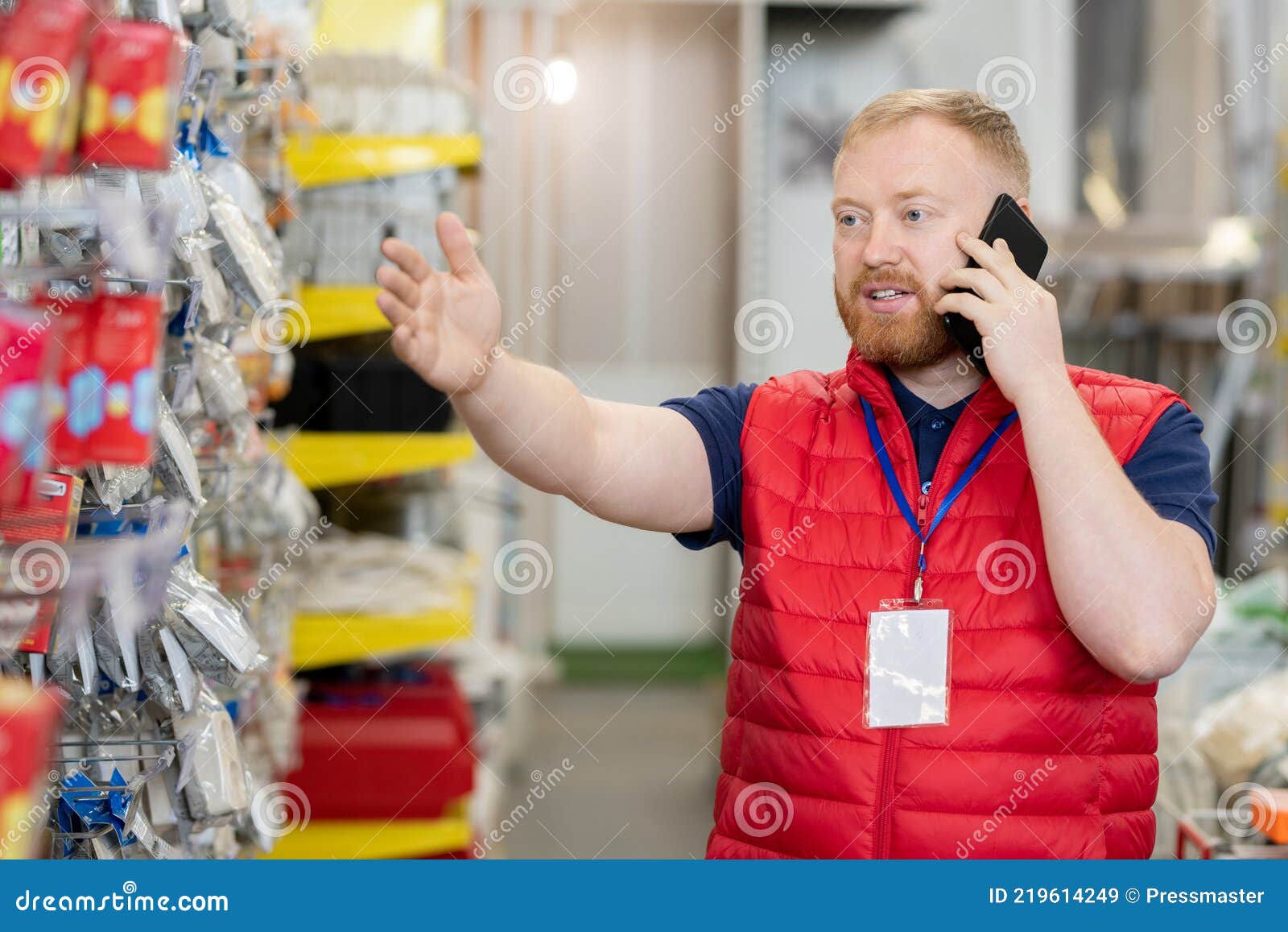 Shop Assistant with Smartphone Showing at Goods Stock Image - Image of ...
