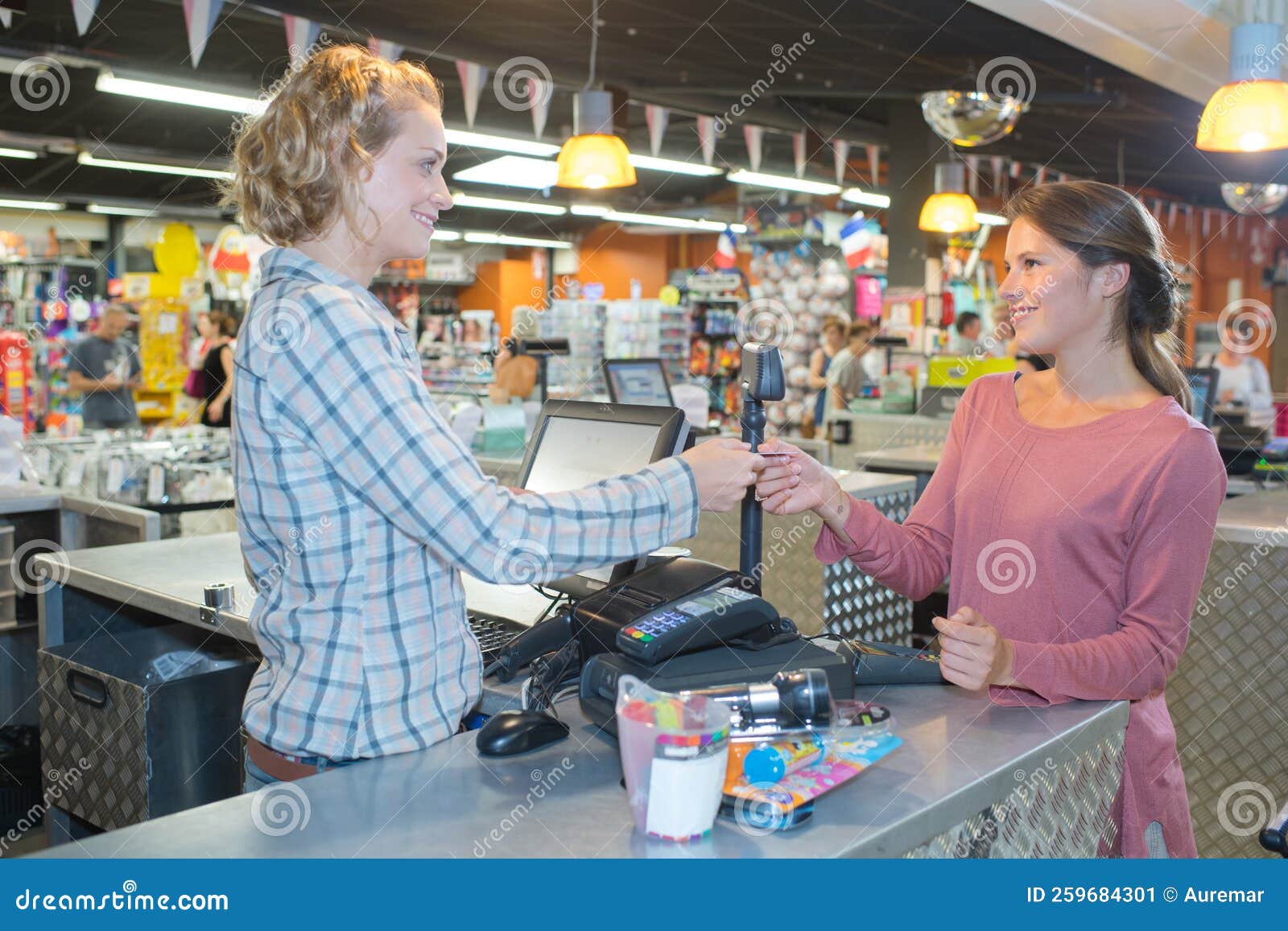 Shop Assistant Taking Card from Customer at Checkout Stock Image ...