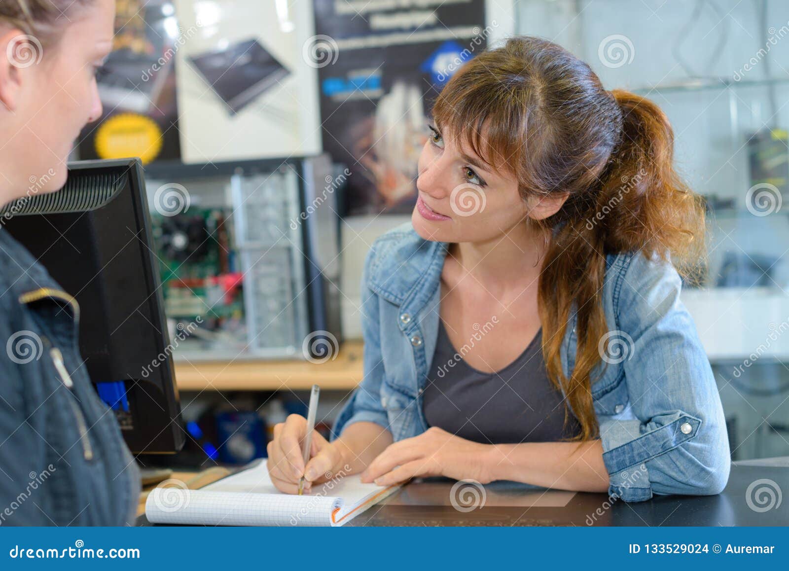 Shop Assistant Taking Notes from Customer Stock Photo - Image of women ...