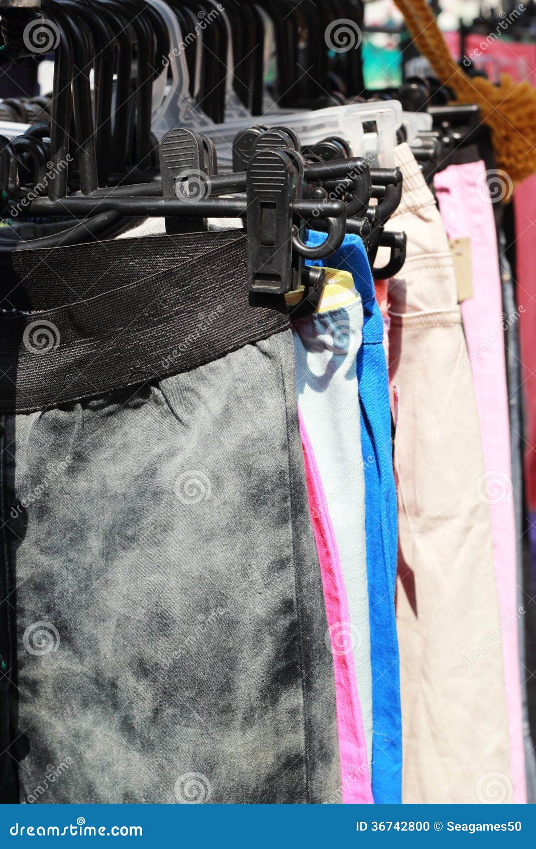 Shop Pants Hanging on a Rack Market. Stock Photo - Image of isolated ...
