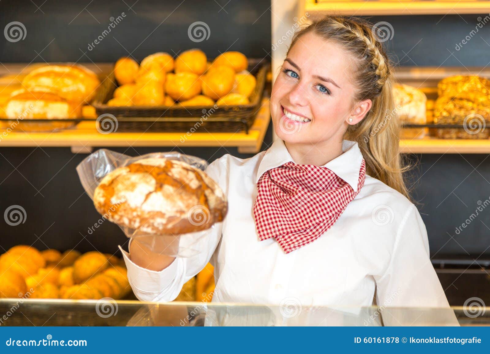 Shopkeeper in Bakery Presenting Loaf of Bread To Client Stock Photo ...